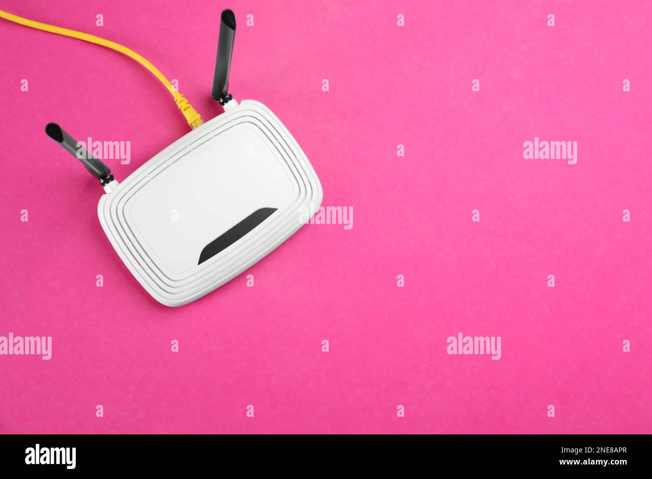 Modern Wi-Fi router on pink background, top view. Space for text Stock ...