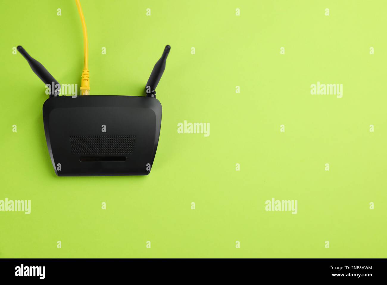 Modern Wi-Fi router on green background, top view. Space for text Stock ...