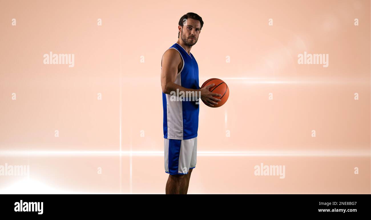 Composition of male basketball player holding basketball with copy ...