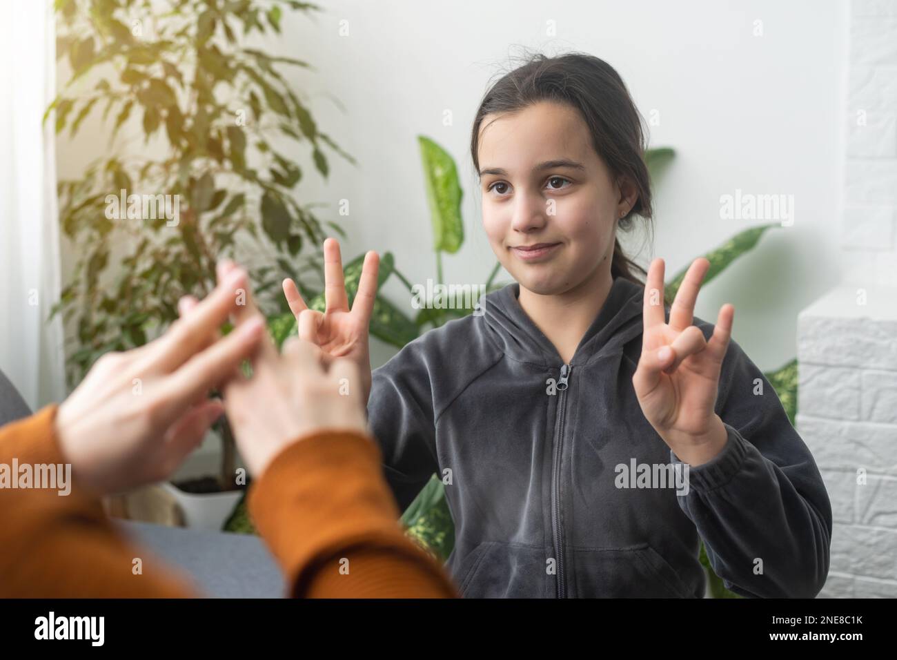 Small Caucasian teen girl child do articulation exercises with caring ...