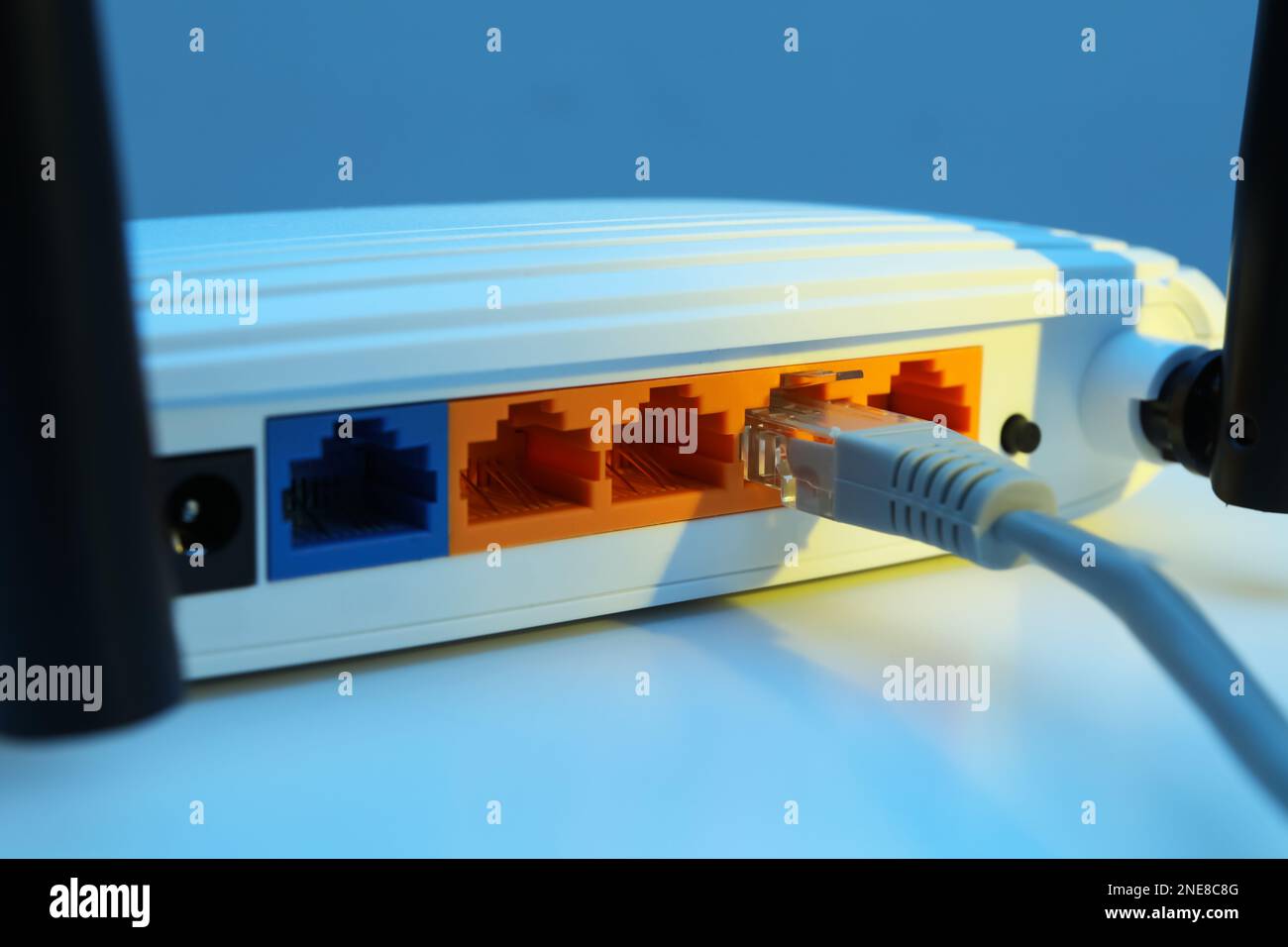 Connected cable to router on white table, closeup. Wireless internet ...