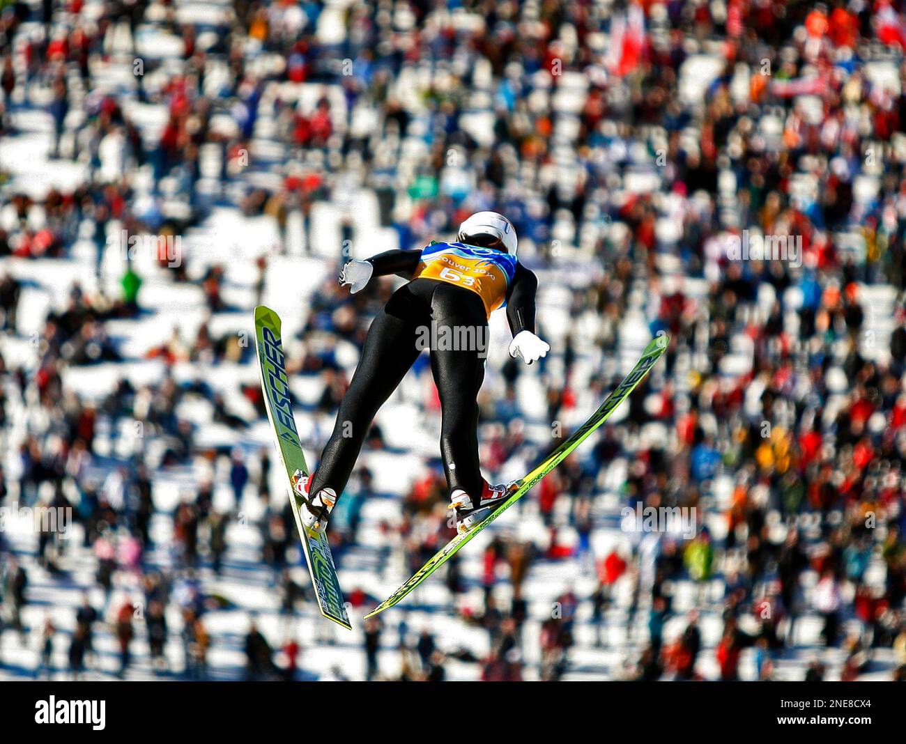 Japan's Shohei Tochimoto soars over the crowd during the team ski ...