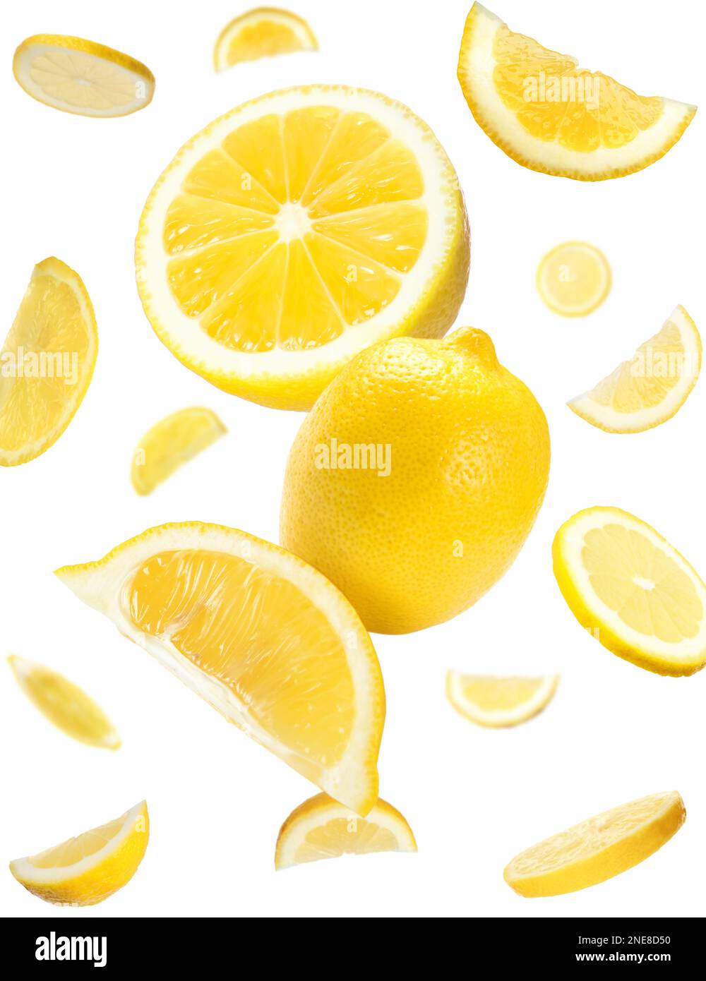 Fresh cut lemons flying on white background Stock Photo - Alamy