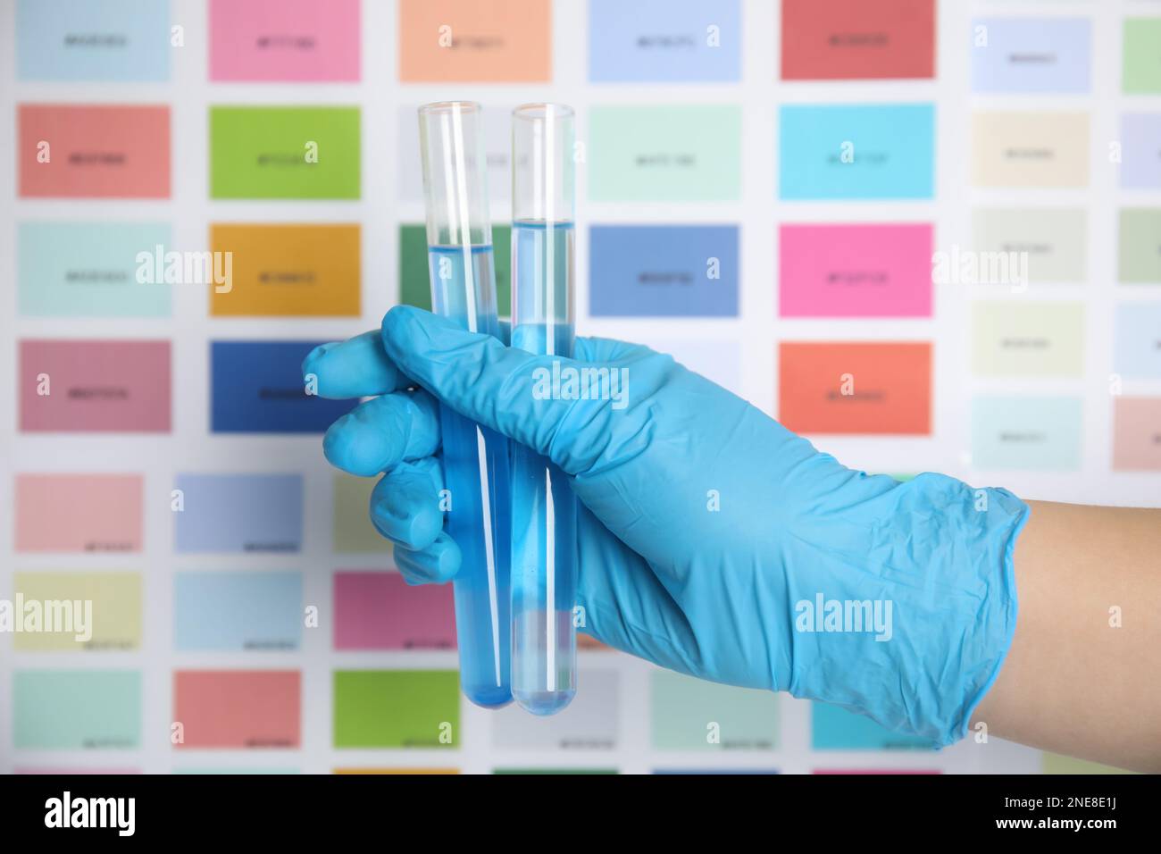 Doctor holding test tubes with liquid near sample chart, closeup Stock ...