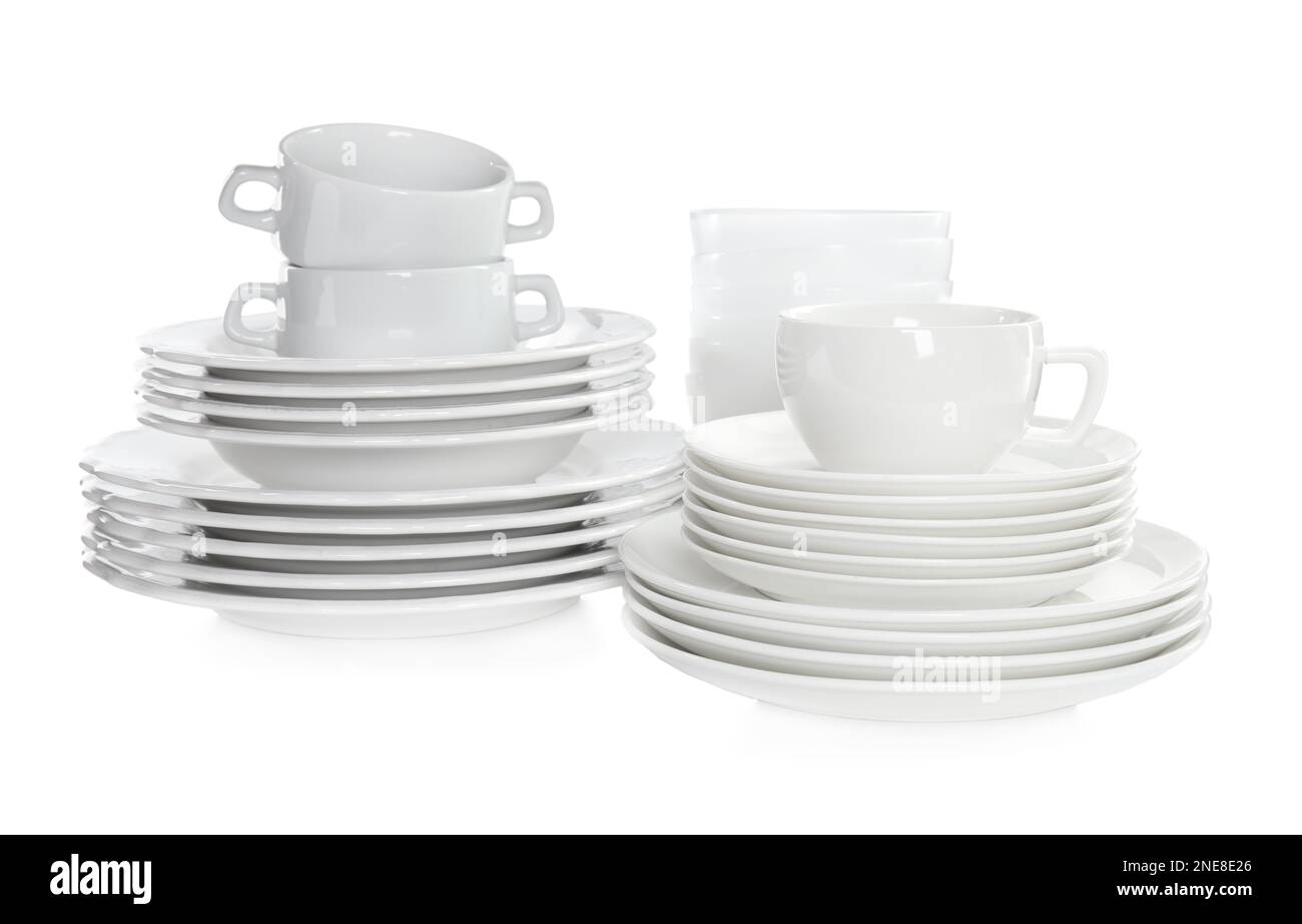 Stacked plates and cups on white background Stock Photo - Alamy