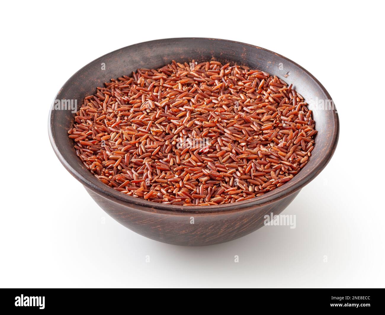Uncooked red rice in ceramic bowl isolated on white background with ...