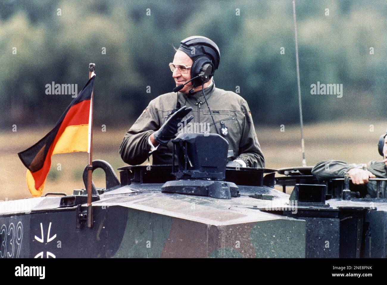 West German Chancellor Helmut Kohl in military gear abord a German tank ...