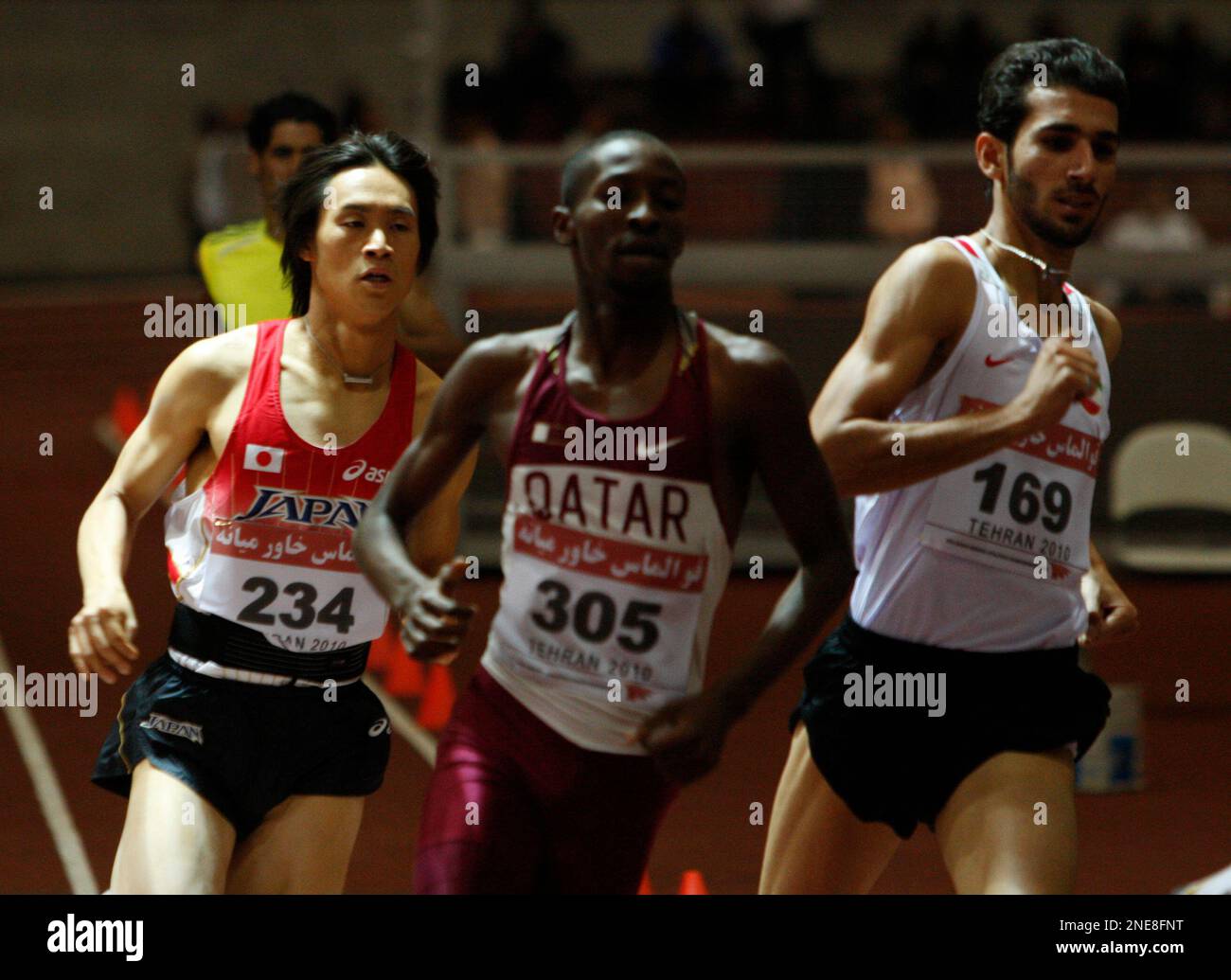 Yokota Masato of Japan, left, follows Qatari Bala Musaaba, center, and ...