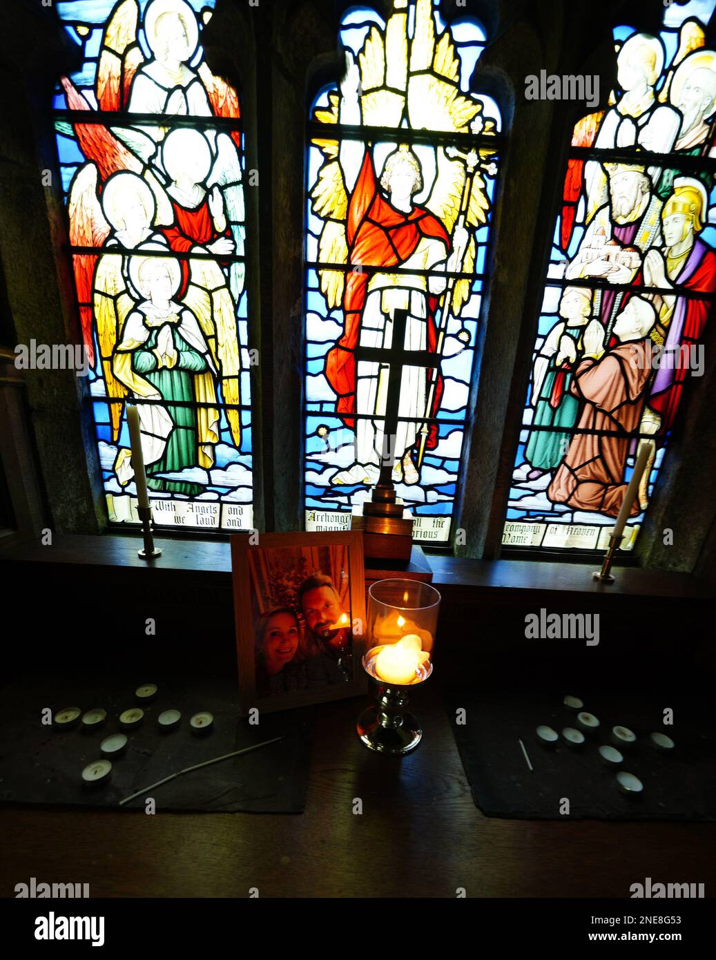 A candle is lit in front of a photo of Nicola Bulley (left) and her ...