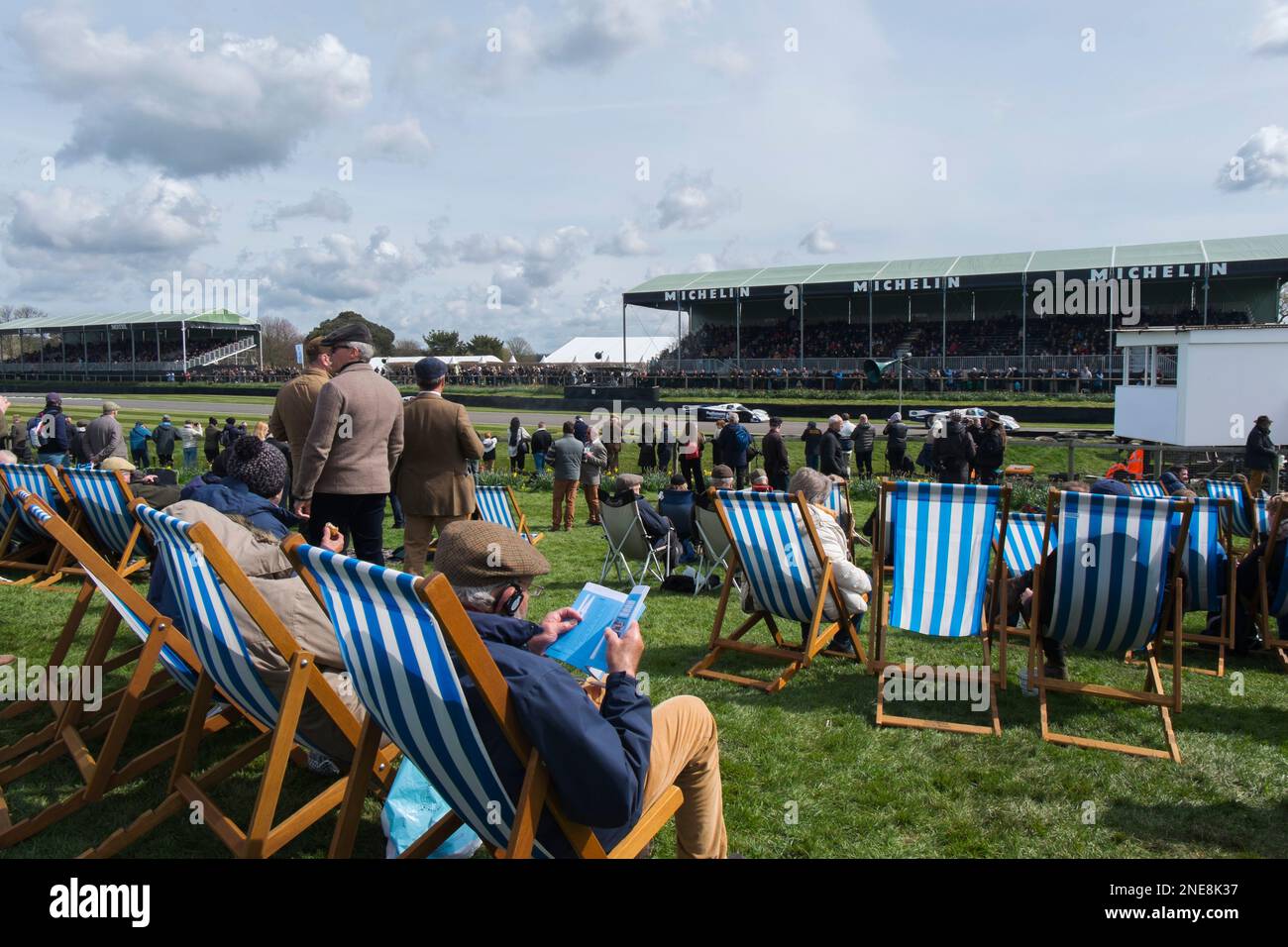 Spectators sitting in blue and white striped deckchairs at the Chicane ...