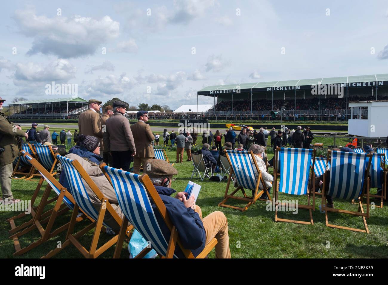 Spectators sitting in blue and white striped deckchairs at the Chicane ...