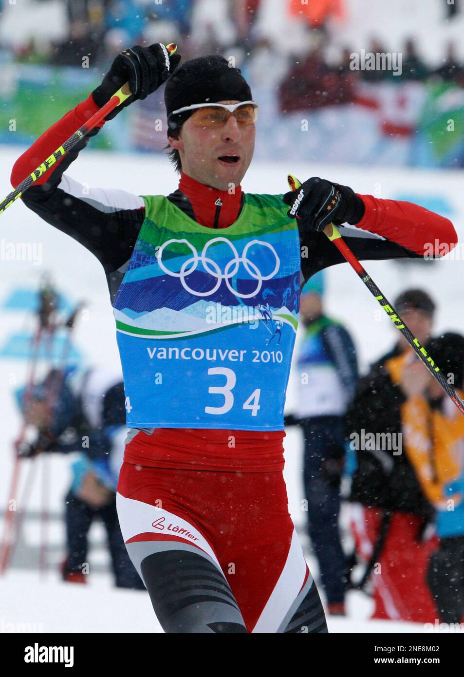 Austria's Mario Stecher crosses the finish line to winning the gold ...