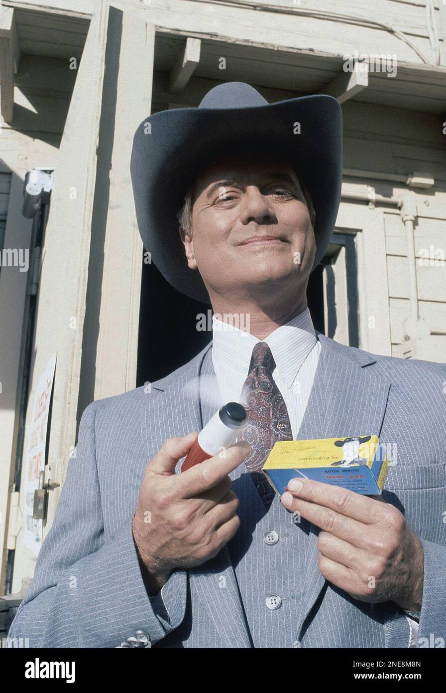 Actor Larry Hagman with battery-powered fan used to blow cigarette ...