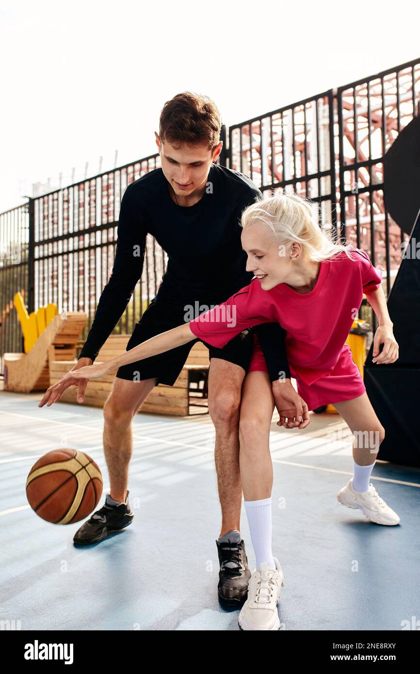 Diversity guy and girl playing basketball on the city playground Stock ...