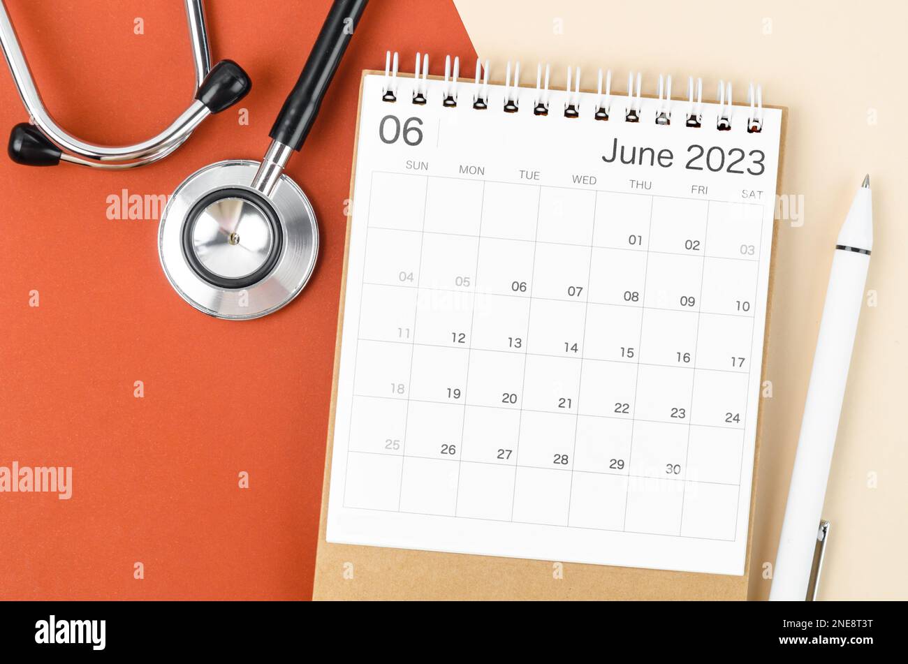 Stethoscope medical and June 2023 desk calendar with pen on the ...