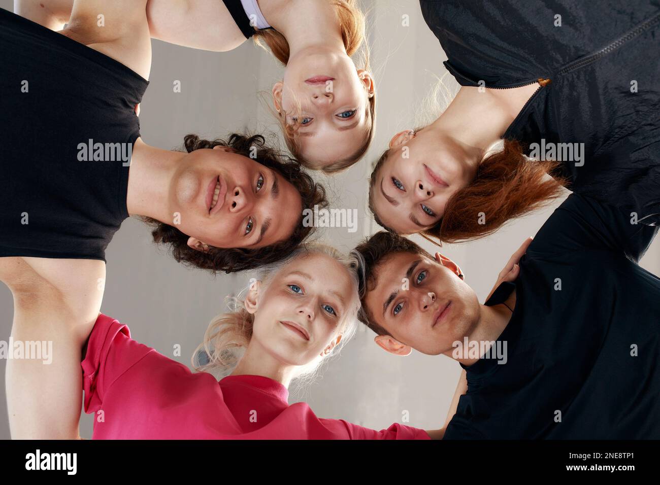 young team of multiracial athletes smiling looking at camera with ...