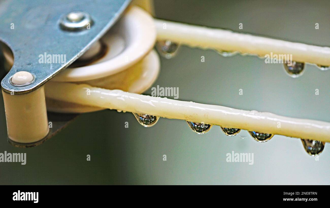 Water drops on the ropes of a clothesline for backgrounds and textures ...