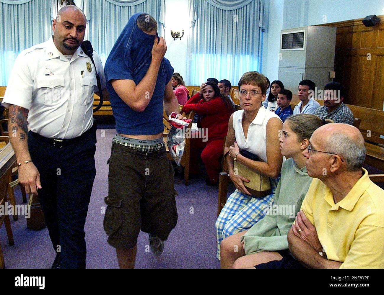 David P. Socha, 17, center, of Paxton, Mass., covers his head while ...