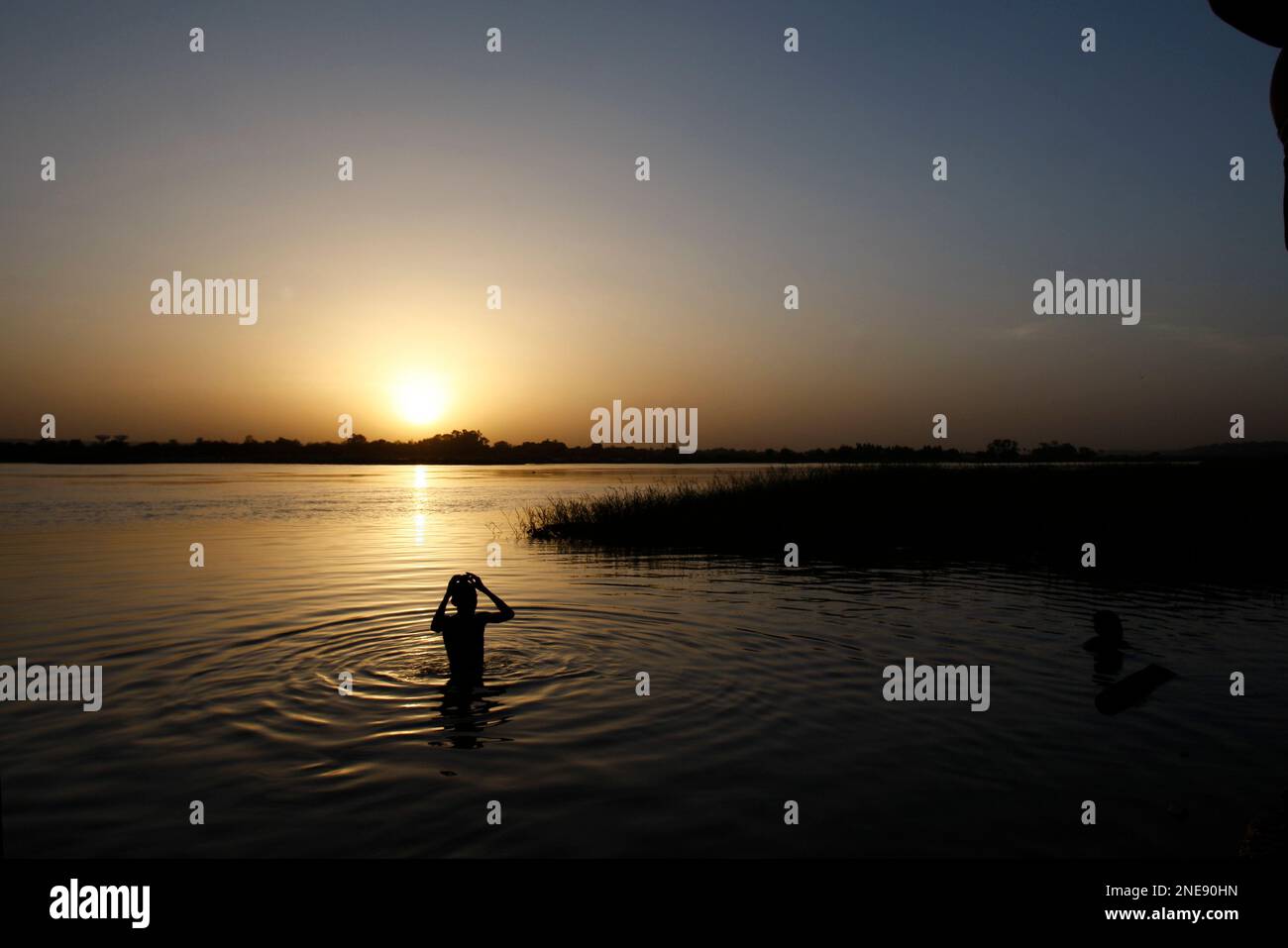 A boy bathes at sunset in the Niger River in Niamey, Niger Monday, Feb ...