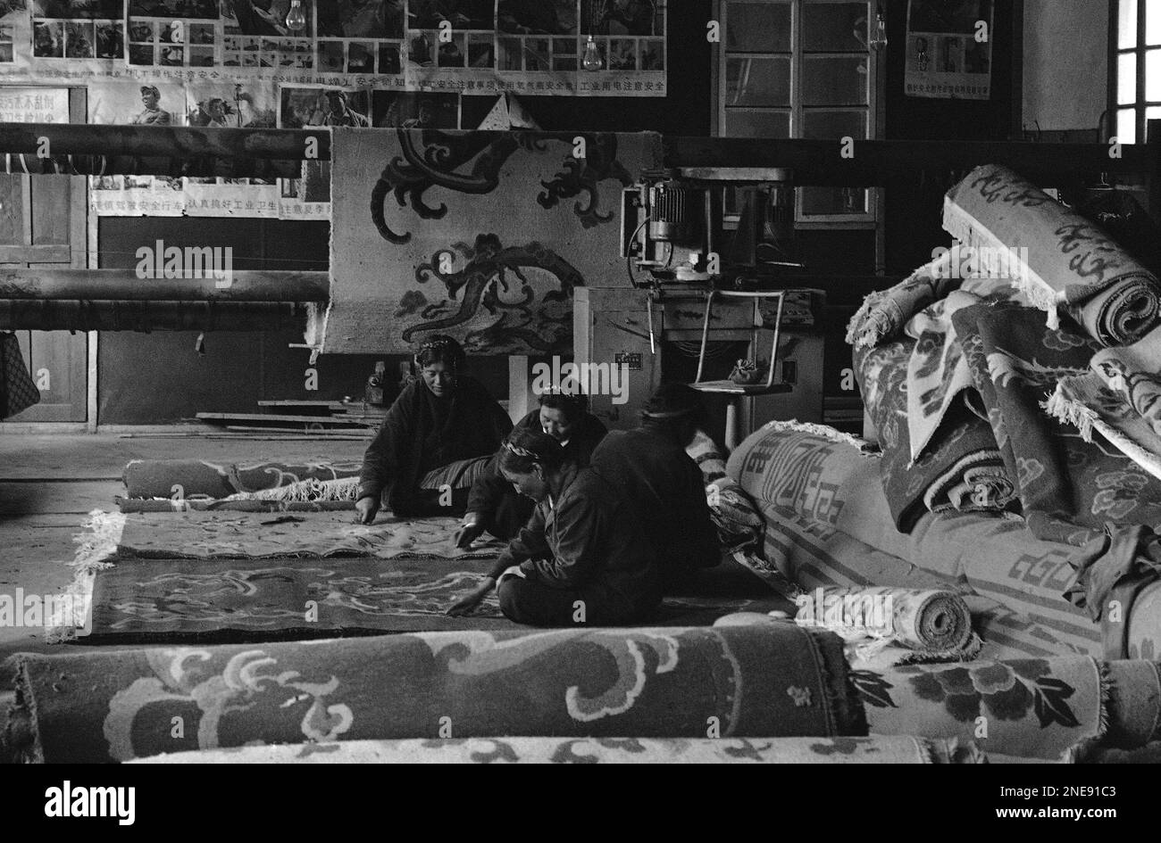 Mary Ann Rowe inspects some rugs in downtown park in Tibet, Feb. 1980 ...