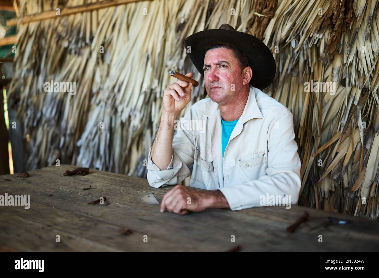a farmer smokes a cigar wearing a cowboy hat Stock Photo - Alamy