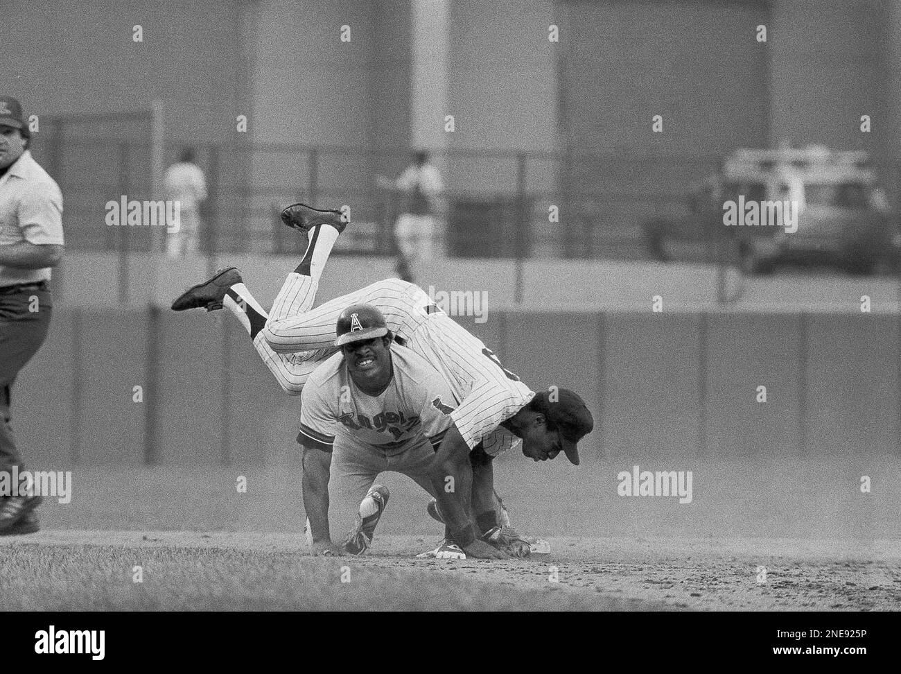 New York Yankees' Willie Randolph falls on top of the California Angels ...
