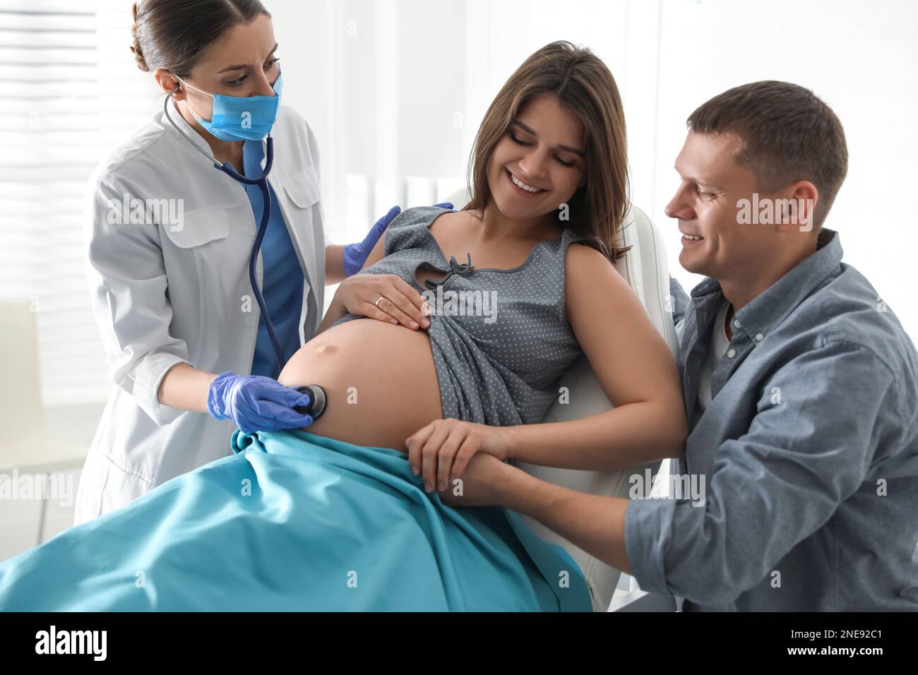 Doctor examining woman before giving child birth in maternity hospital ...