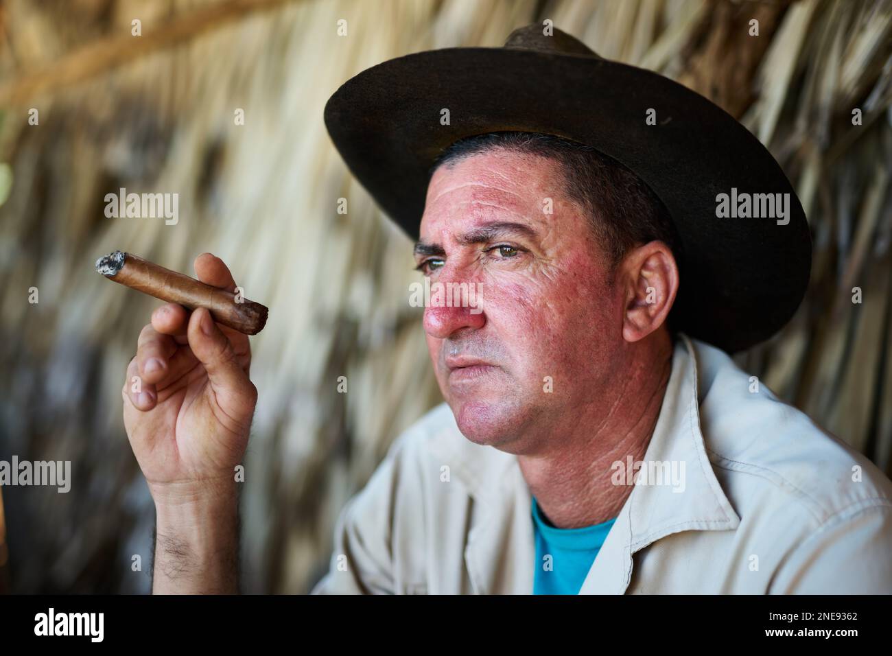 a farmer smokes a cigar wearing a cowboy hat Stock Photo - Alamy