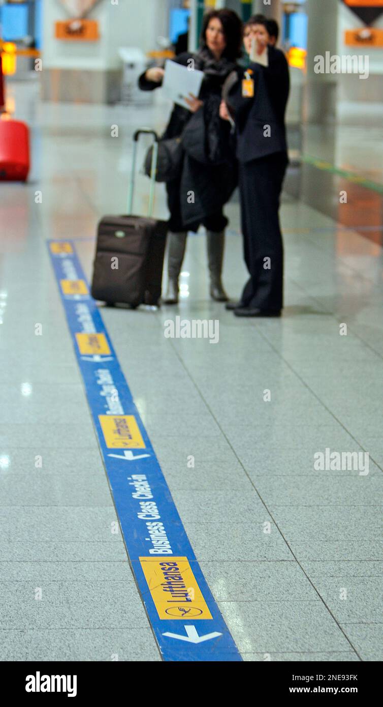 Passengers line up at a Lufthansa Ticket counter during a strike of ...