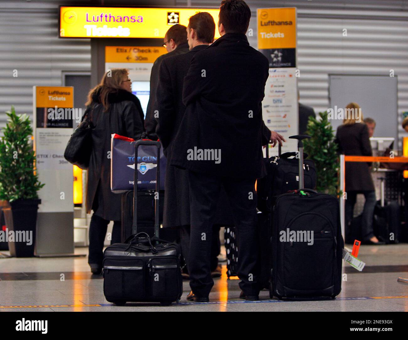 Passengers line up at a Lufthansa ticket counter during a strike of ...