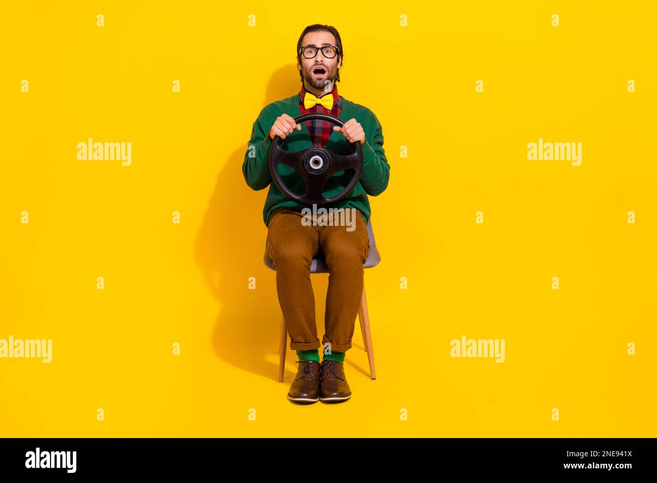 Full body photo of impressed scared guy open mouth sit chair arms hold ...