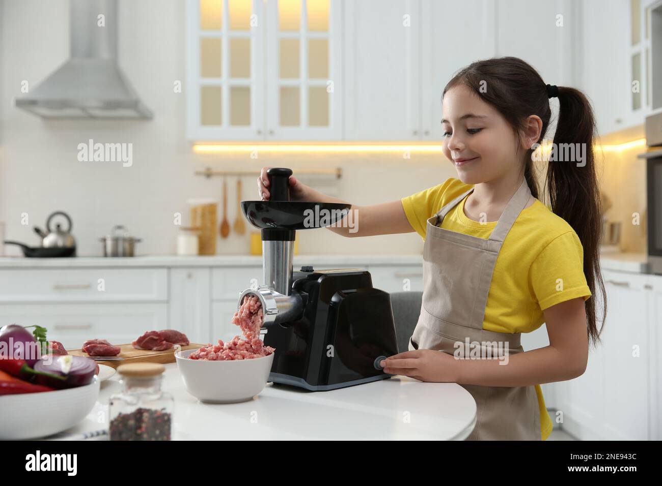 Little girl using modern meat grinder in kitchen Stock Photo - Alamy