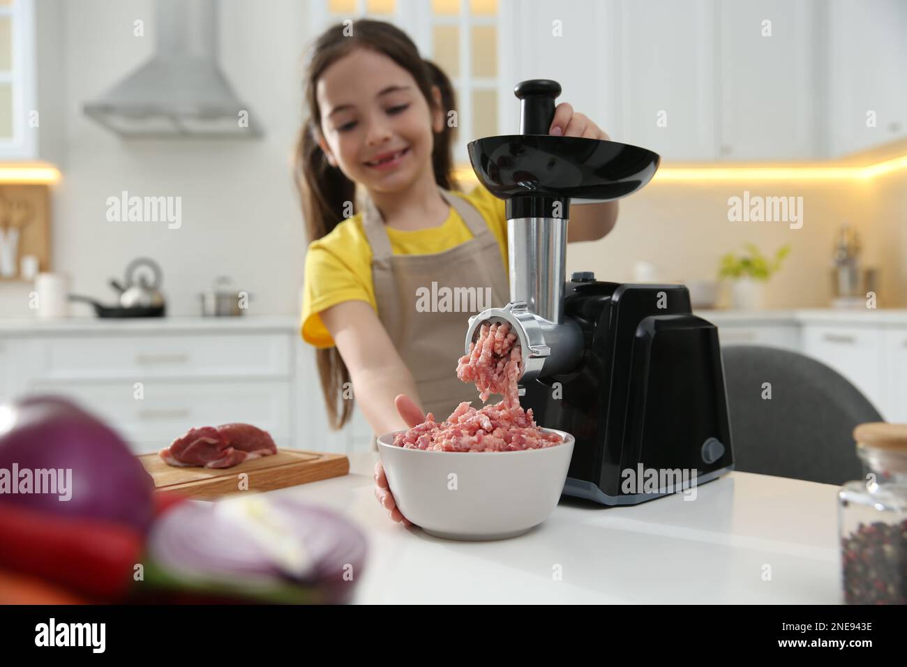 Little girl using modern meat grinder in kitchen Stock Photo - Alamy