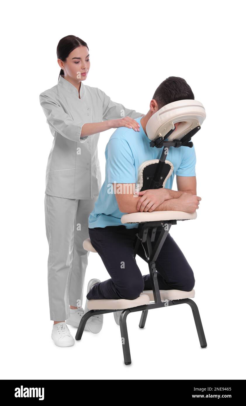 Man receiving massage in modern chair on white background Stock Photo ...