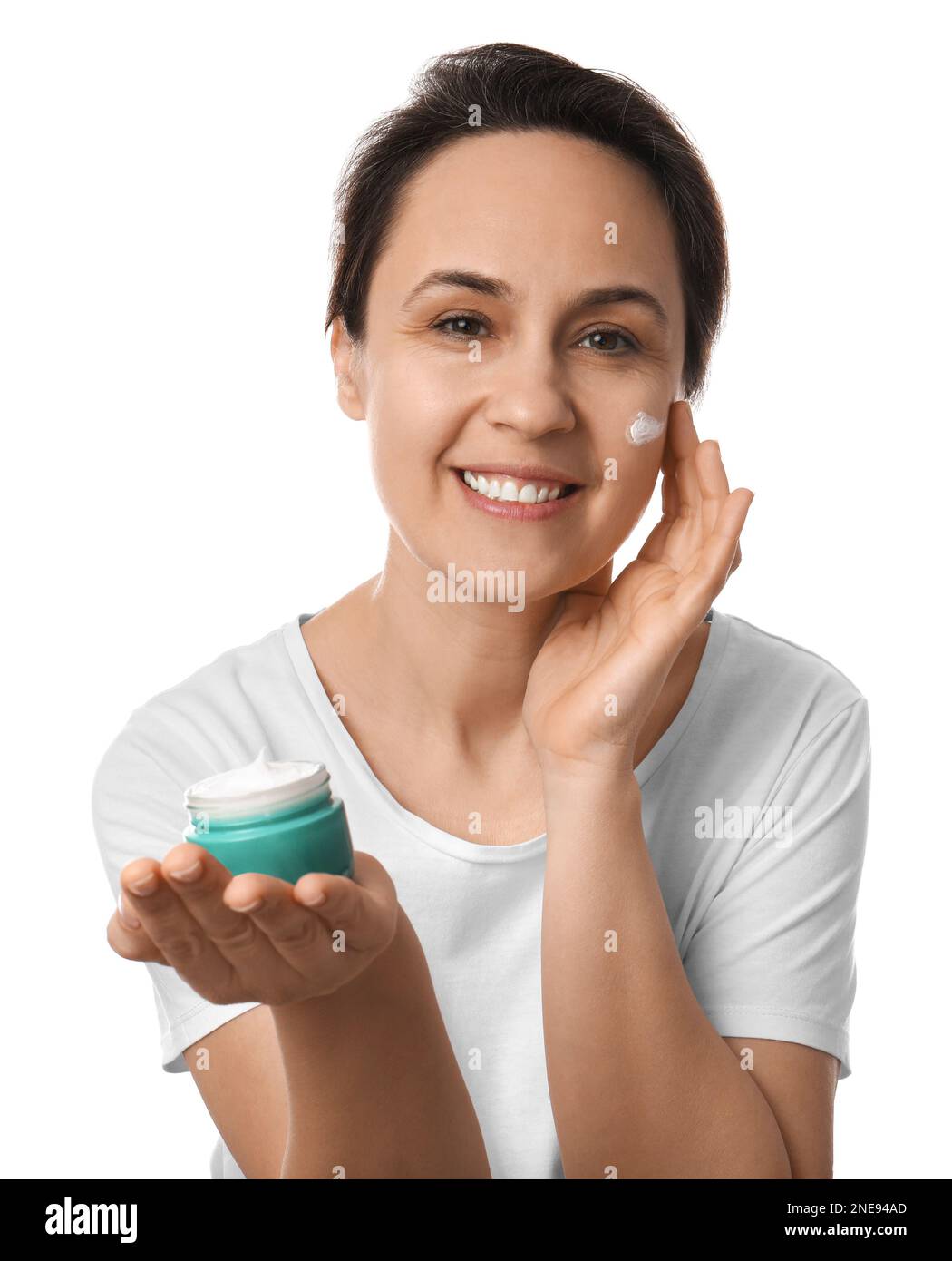 Woman applying facial cream on white background Stock Photo - Alamy