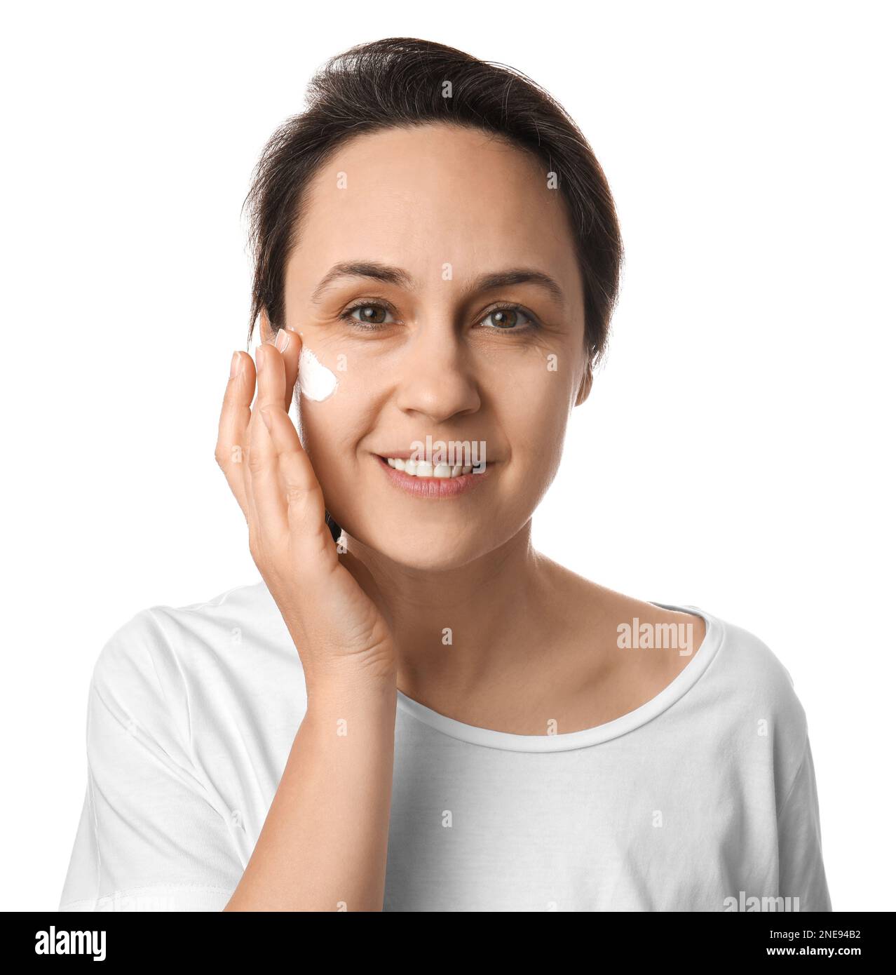 Woman applying facial cream on white background Stock Photo - Alamy