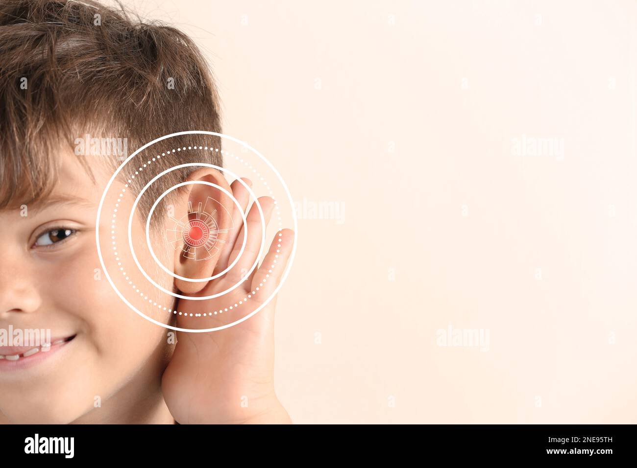 Cute little boy with hearing problem on light background, closeup ...