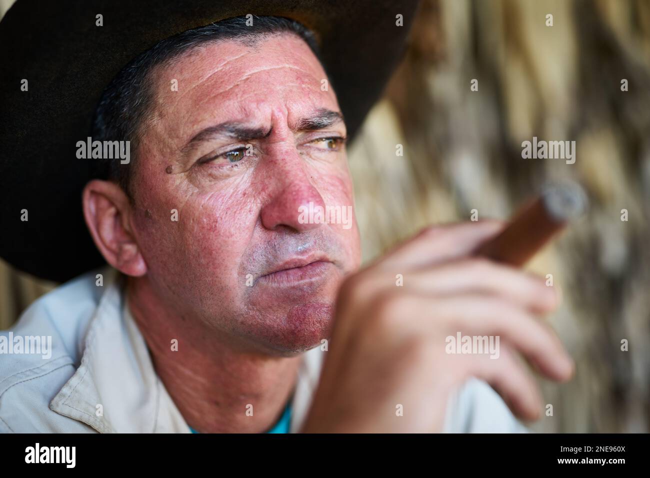 a farmer smokes a cigar wearing a cowboy hat Stock Photo - Alamy