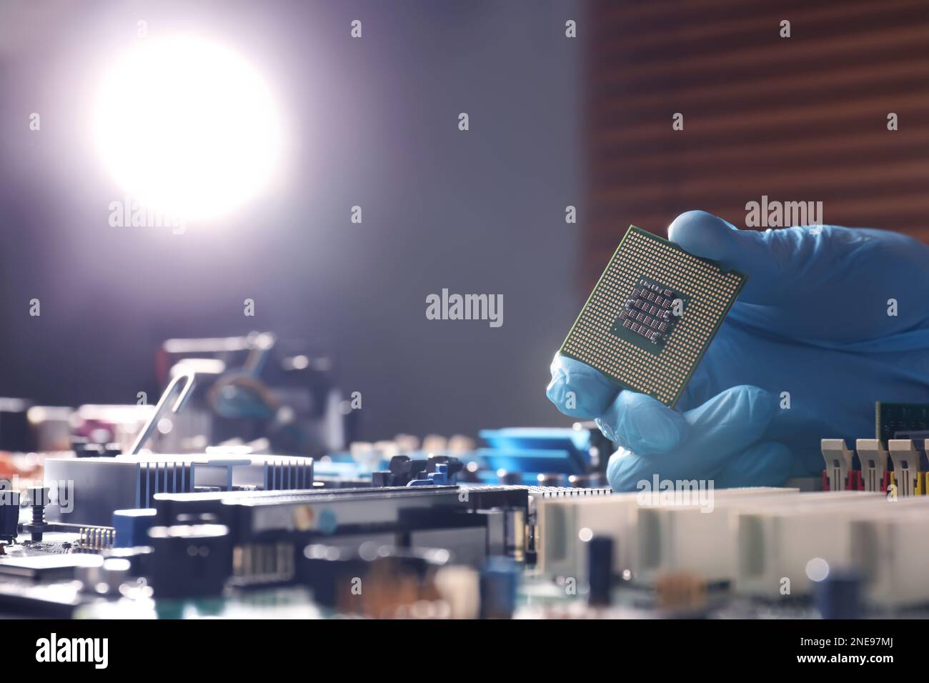 Technician repairing computer motherboard, closeup. Electronic device ...
