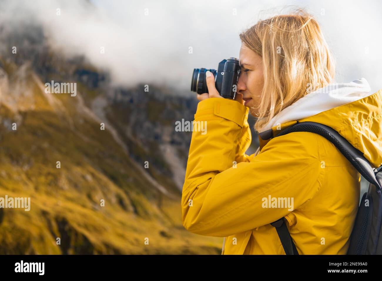 Close up pretty girl taking photos of mountains in Italian Alps on a ...