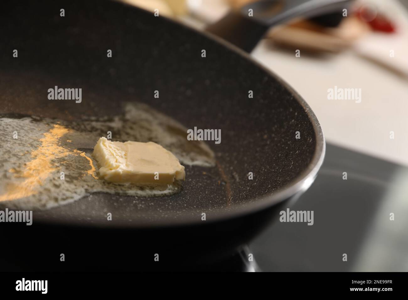 Frying pan with melted butter on stove, closeup Stock Photo - Alamy
