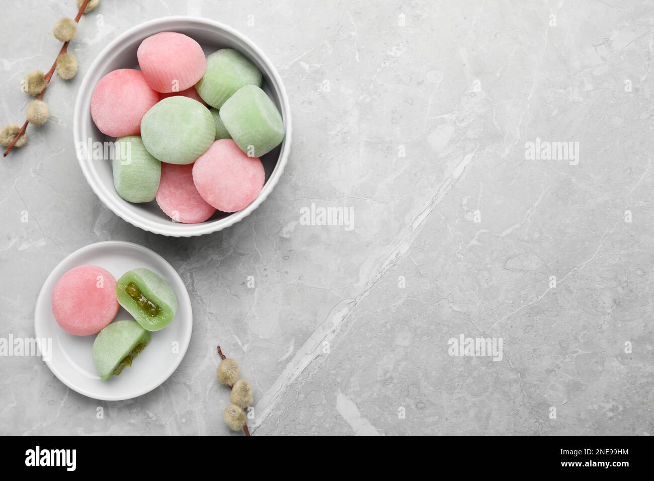 Delicious mochi and willow branches on light grey marble table, flat ...