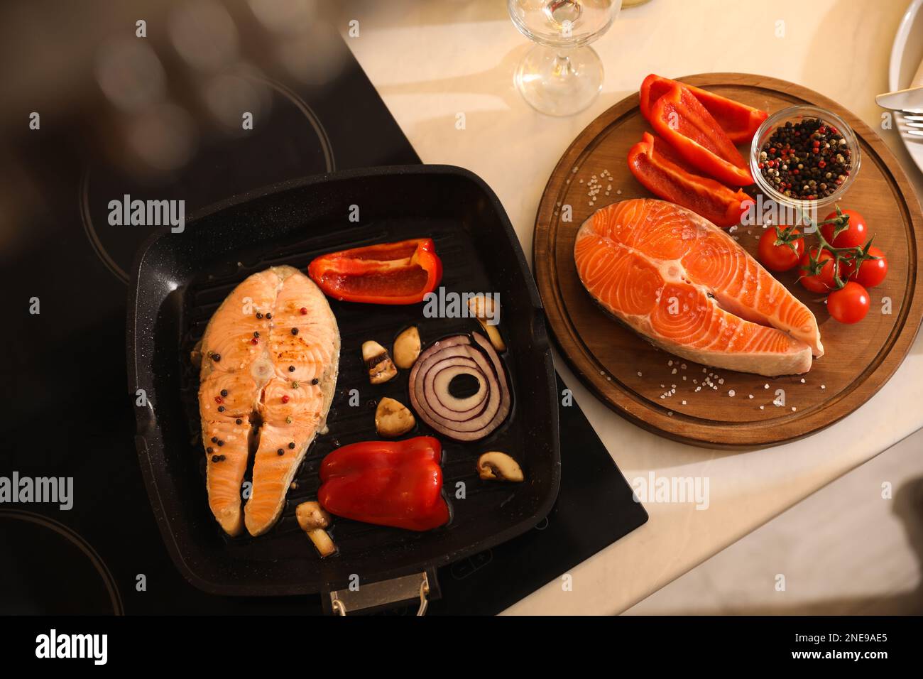 Composition with salmon steaks and vegetables in frying pan, above view ...