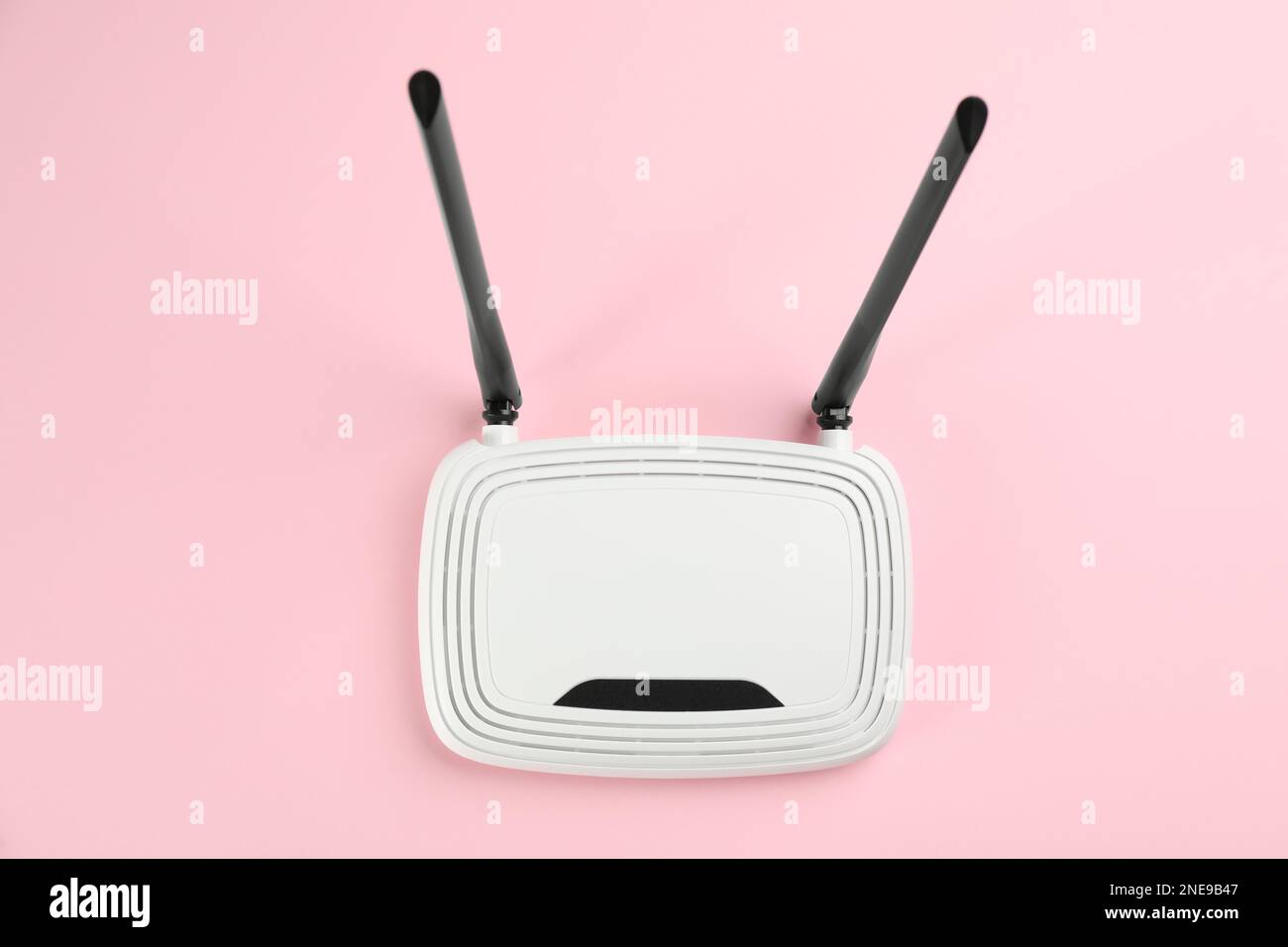 Modern Wi-Fi router on light pink background, top view Stock Photo - Alamy