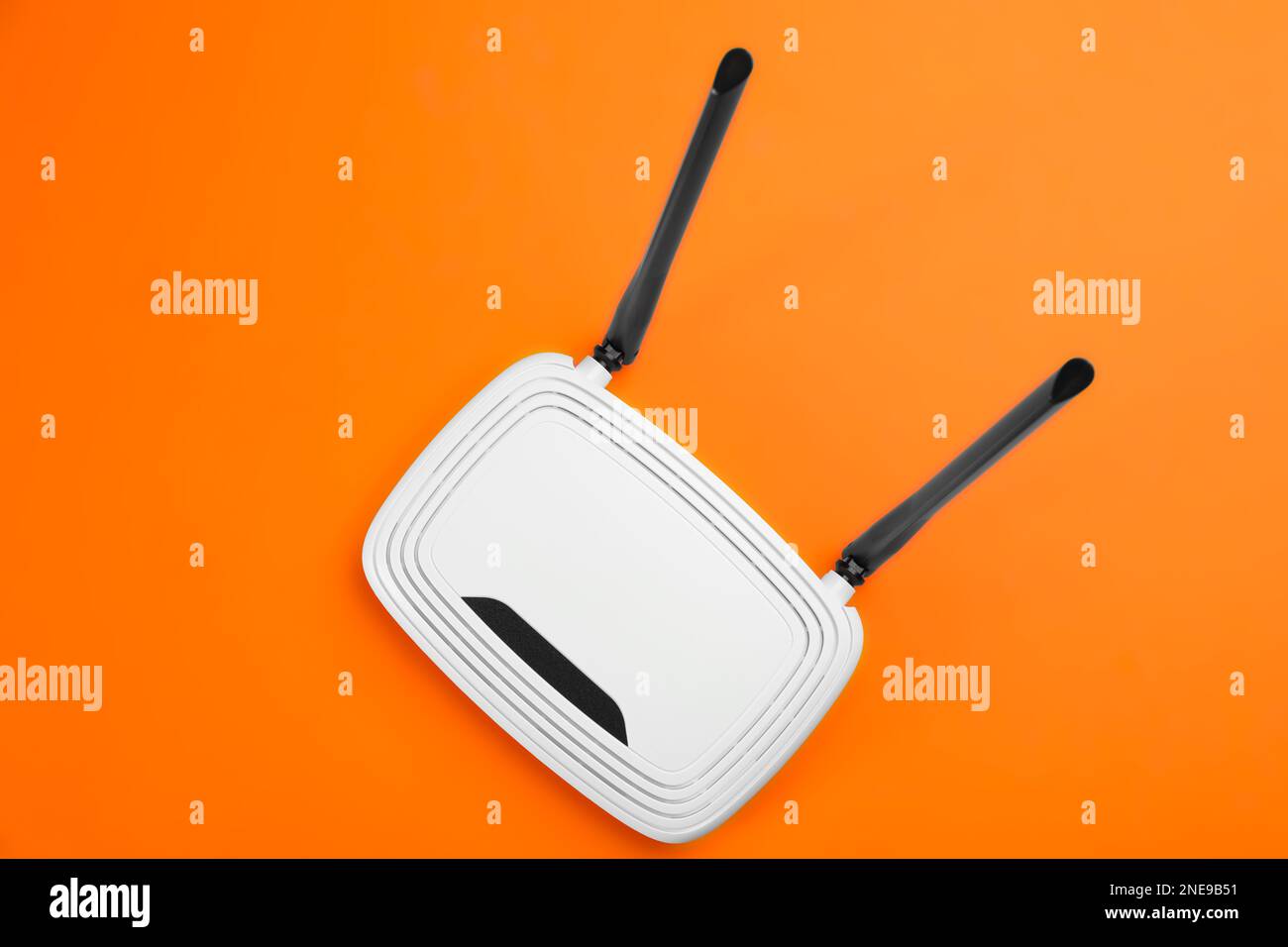 Modern Wi-Fi router on orange background, top view Stock Photo - Alamy