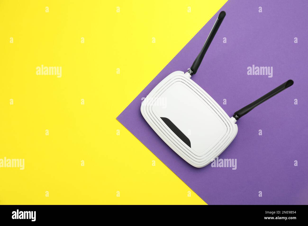 Modern Wi-Fi router on color background, top view. Space for text Stock ...