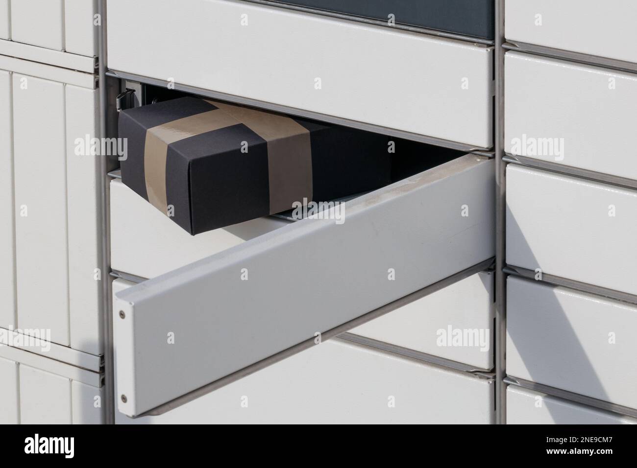 Parcel in the automatic mailbox cabinet. Black parcel in the outbox ...