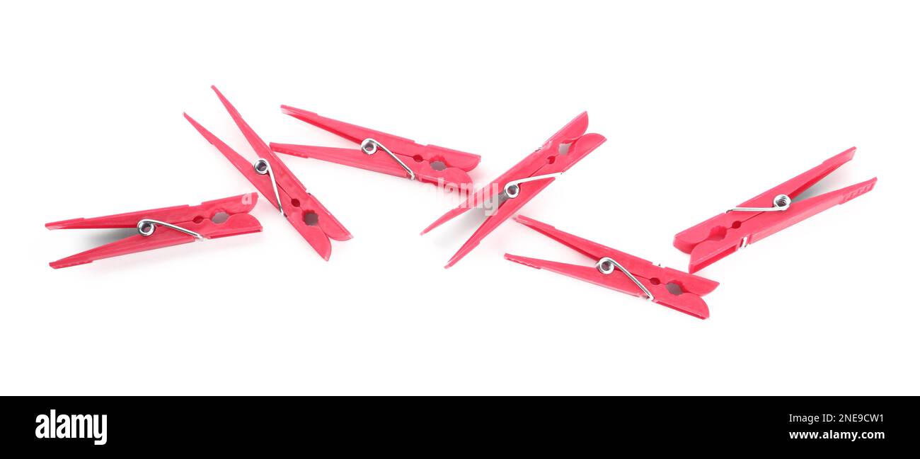 Bright pink plastic clothespins on white background, top view Stock ...