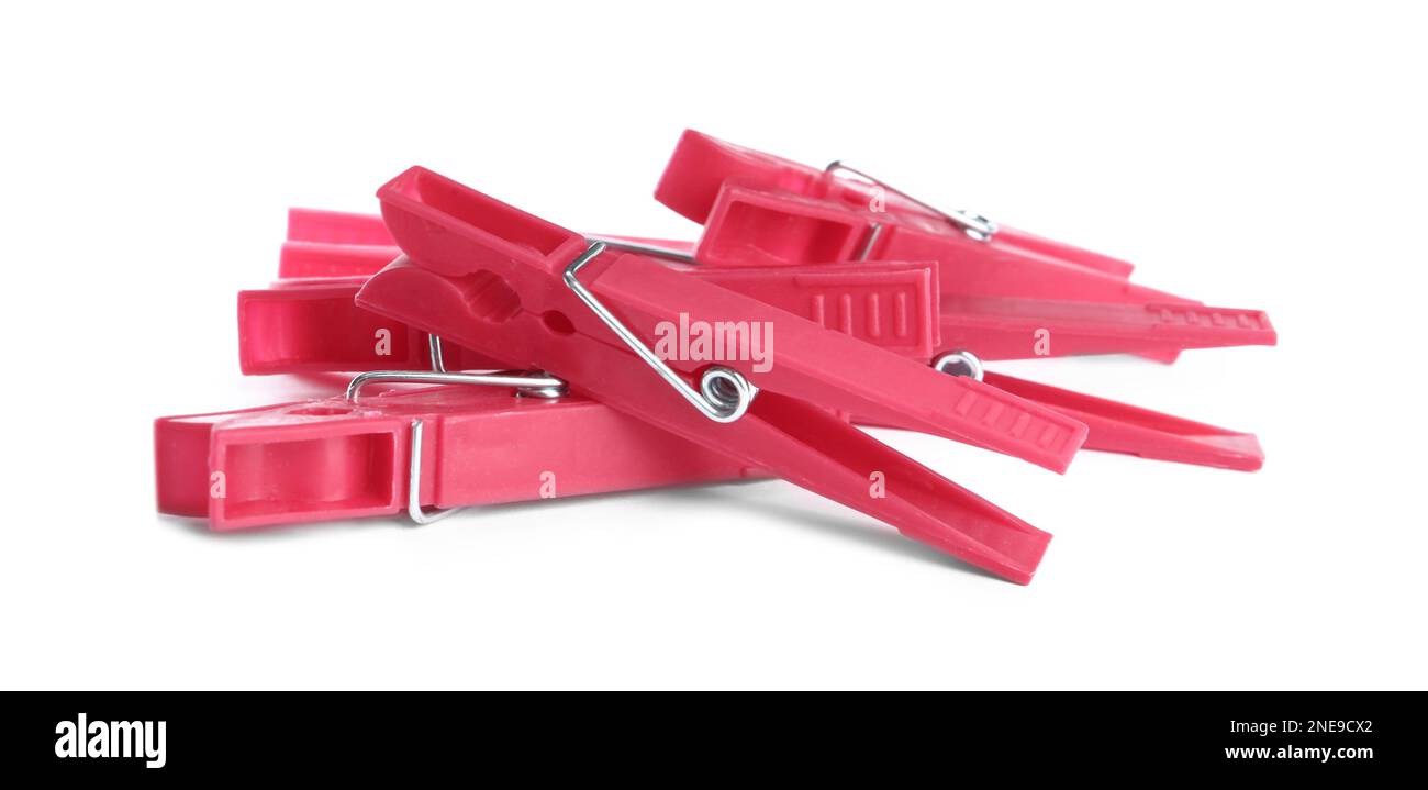 Bright pink plastic clothespins on white background Stock Photo - Alamy