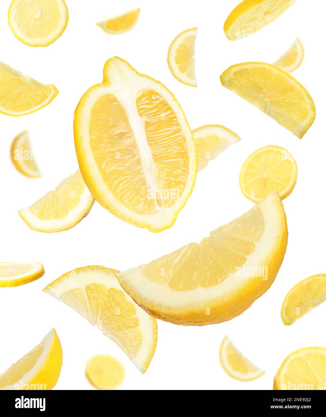 Fresh cut lemons flying on white background Stock Photo - Alamy